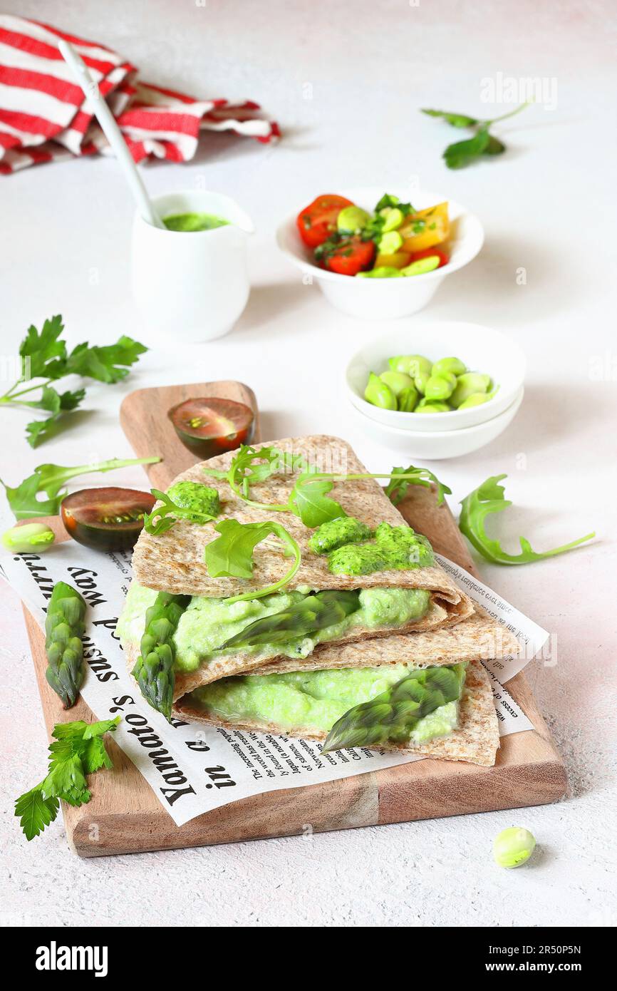 Italian flat bread (Piadina) with ricotta cream, asparagus and broad ...
