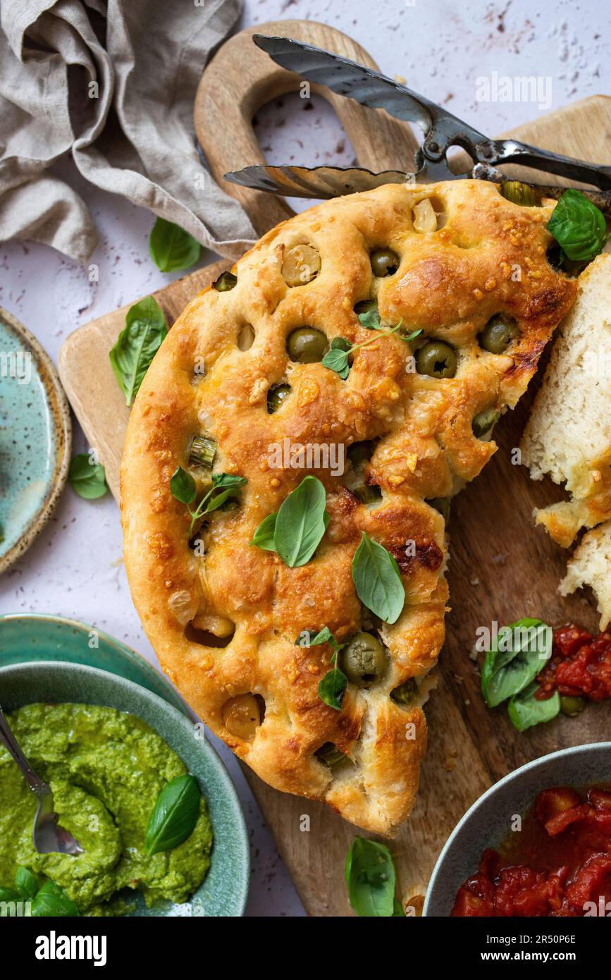Focaccia with green olives, basil, and tomato sauce Stock Photo - Alamy