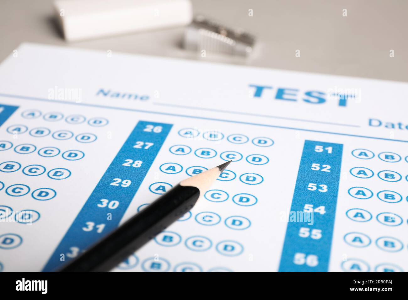 Answer sheet and pencil on light grey table, closeup. Student passing ...