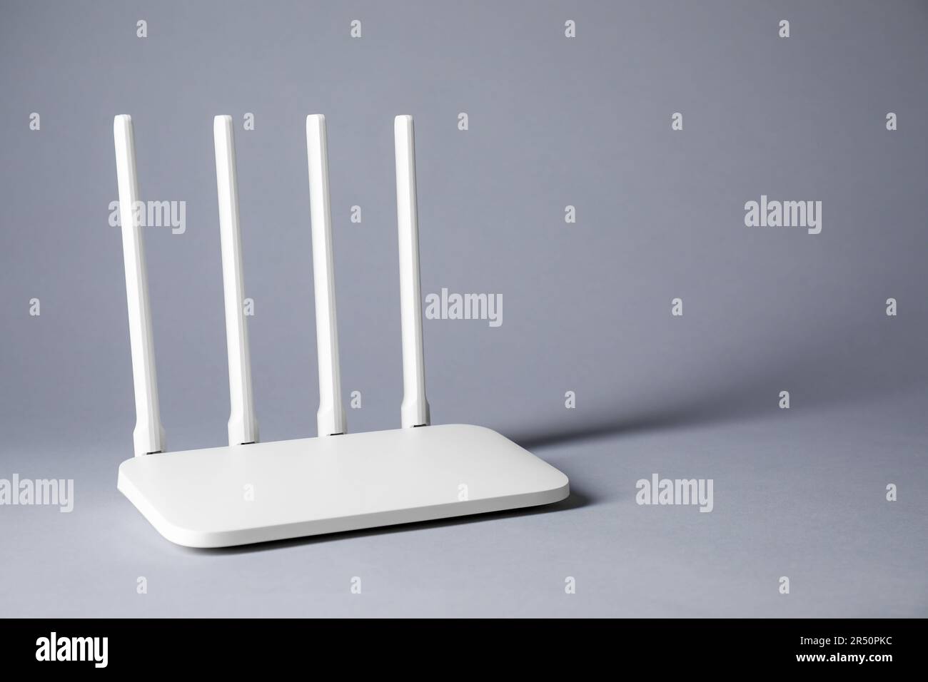 New stylish Wi-Fi router on grey background. Space for text Stock Photo ...