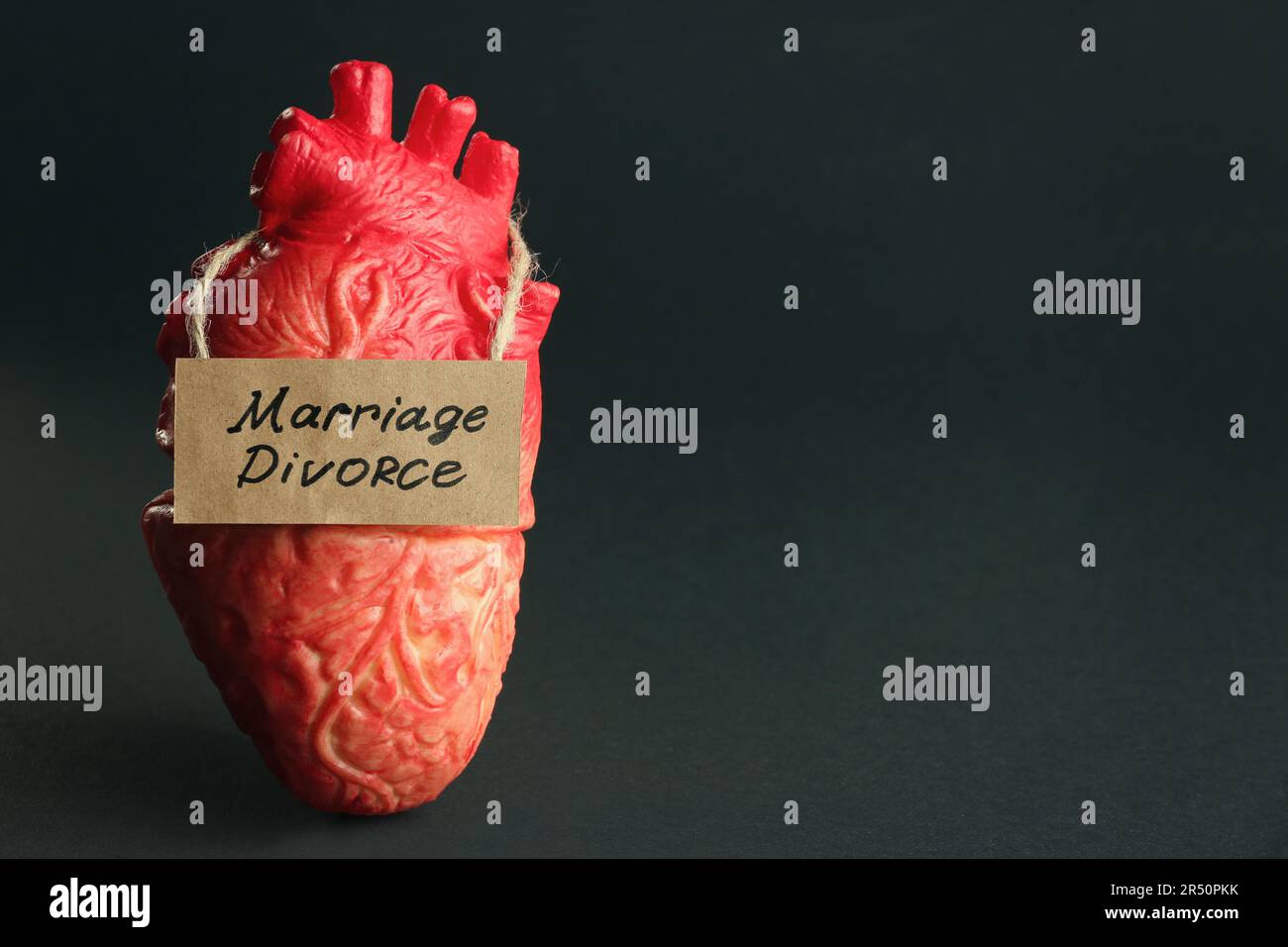 Model of heart and card with words Marriage Divorce on black background ...