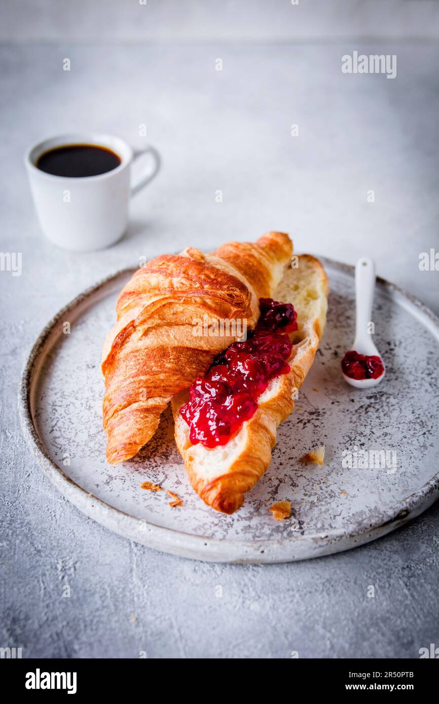 Croissant with raspberry jam Stock Photo - Alamy
