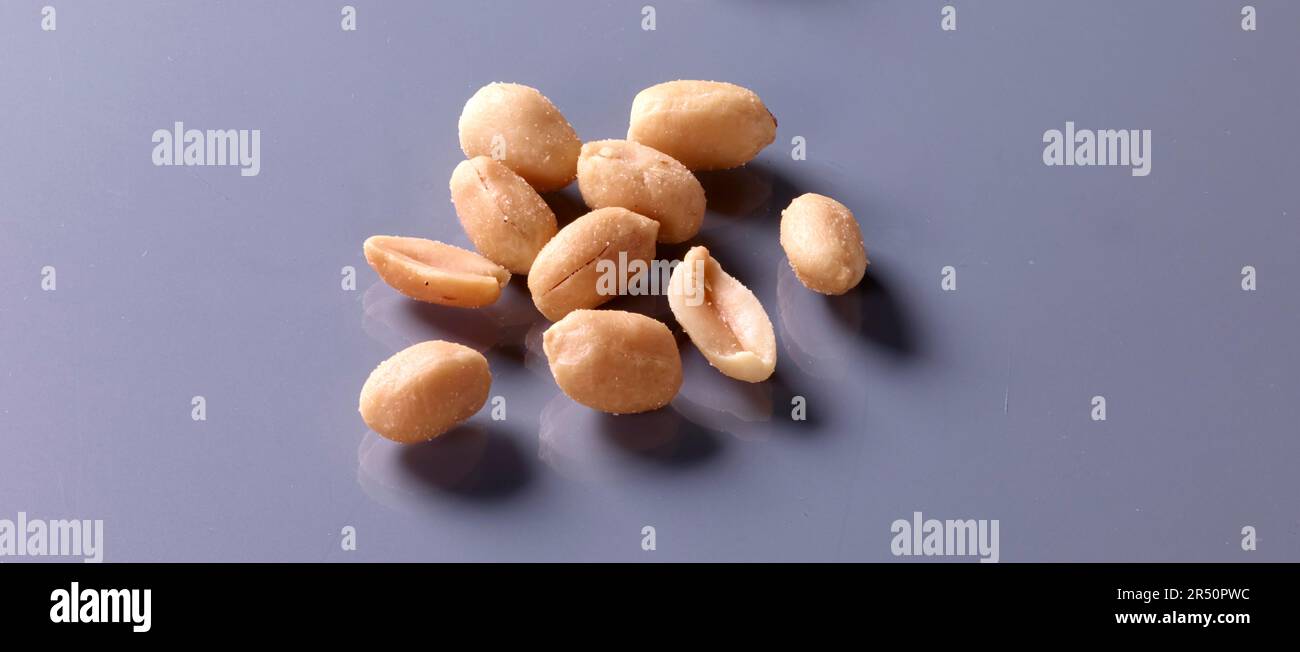 Peanuts on a grey background Stock Photo - Alamy
