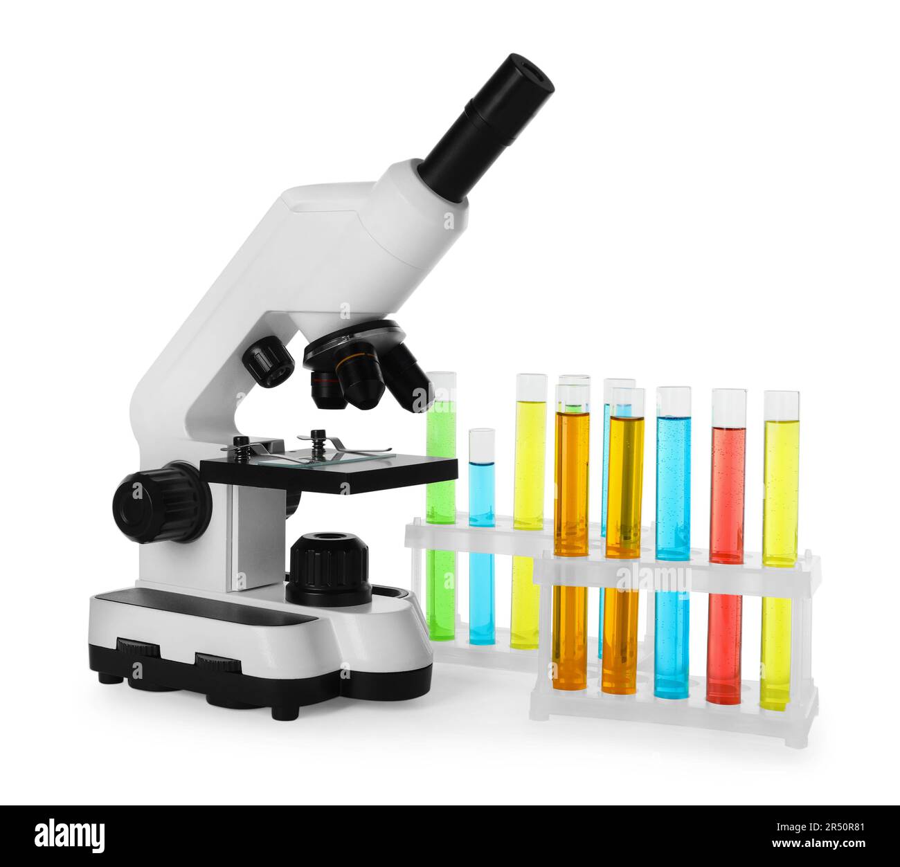 Test tubes with colorful liquids and microscope isolated on white Stock ...