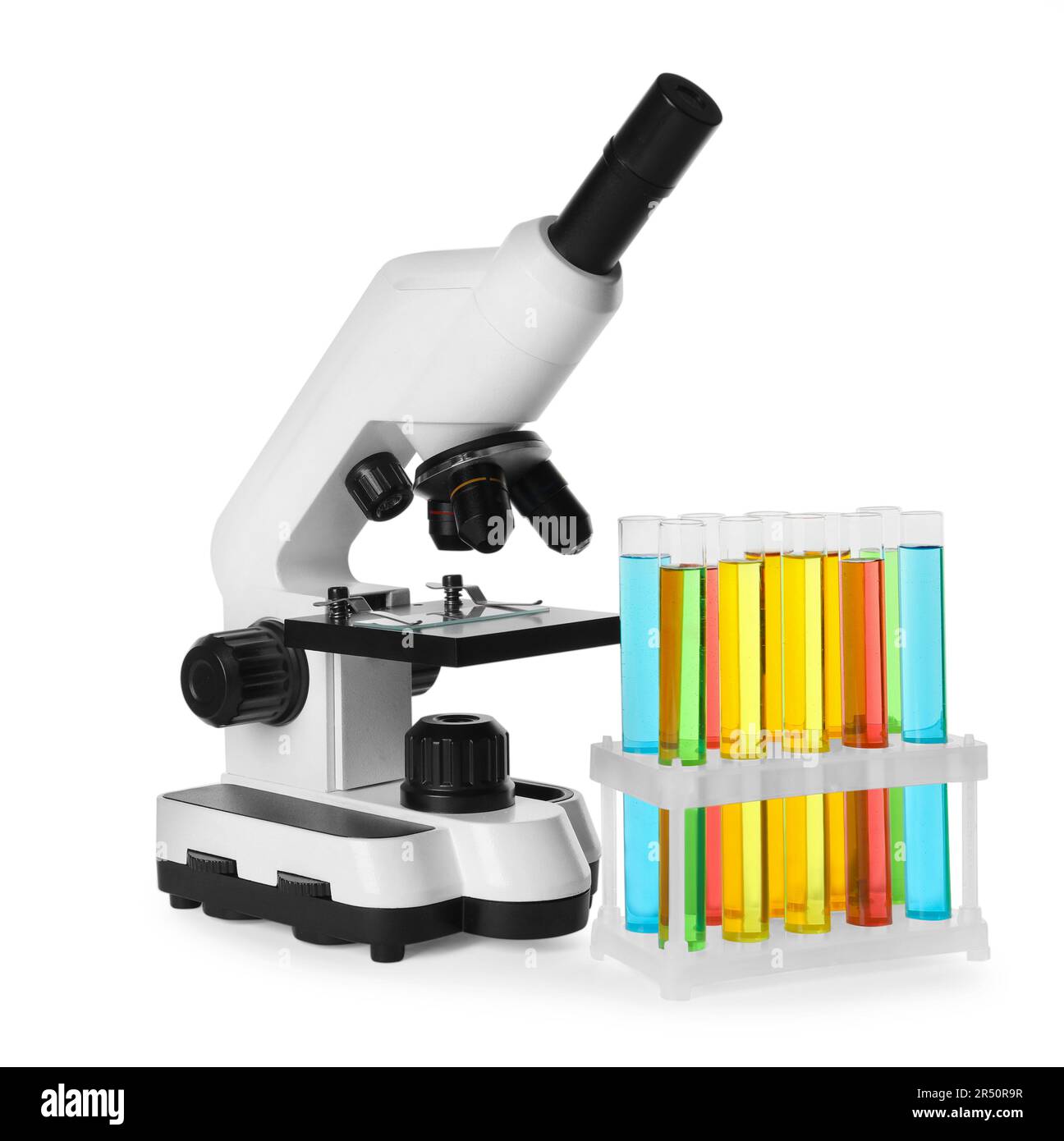 Test tubes with colorful liquids and microscope isolated on white Stock ...