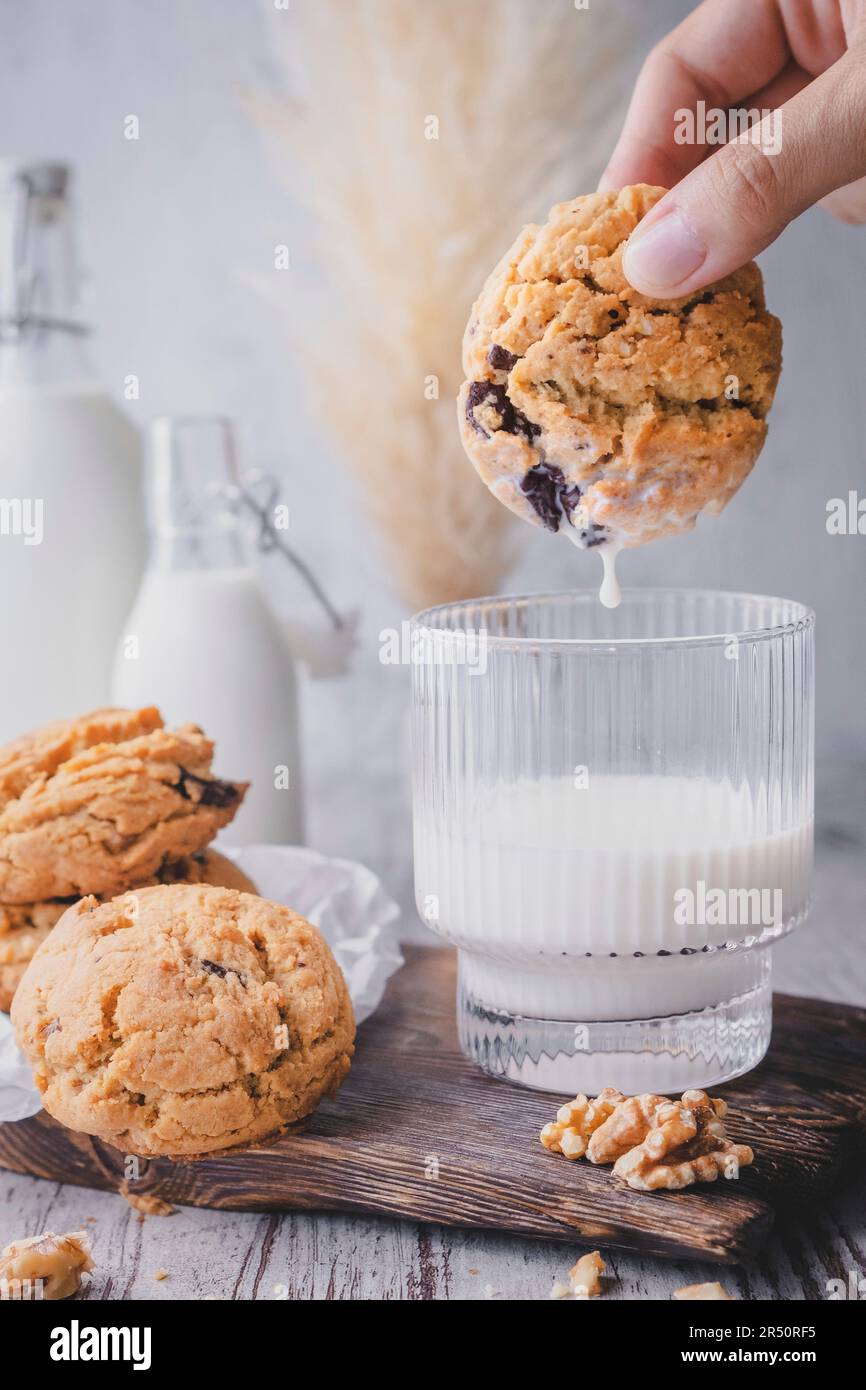 Cookies with chocolate dipped in milk Stock Photo - Alamy