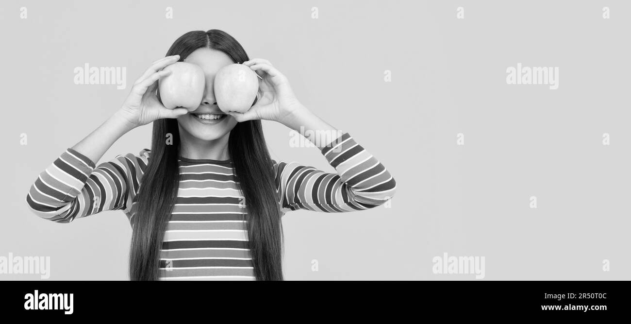 Apples improve your eyesight. Happy child hold apples at eyes. Fruit ...