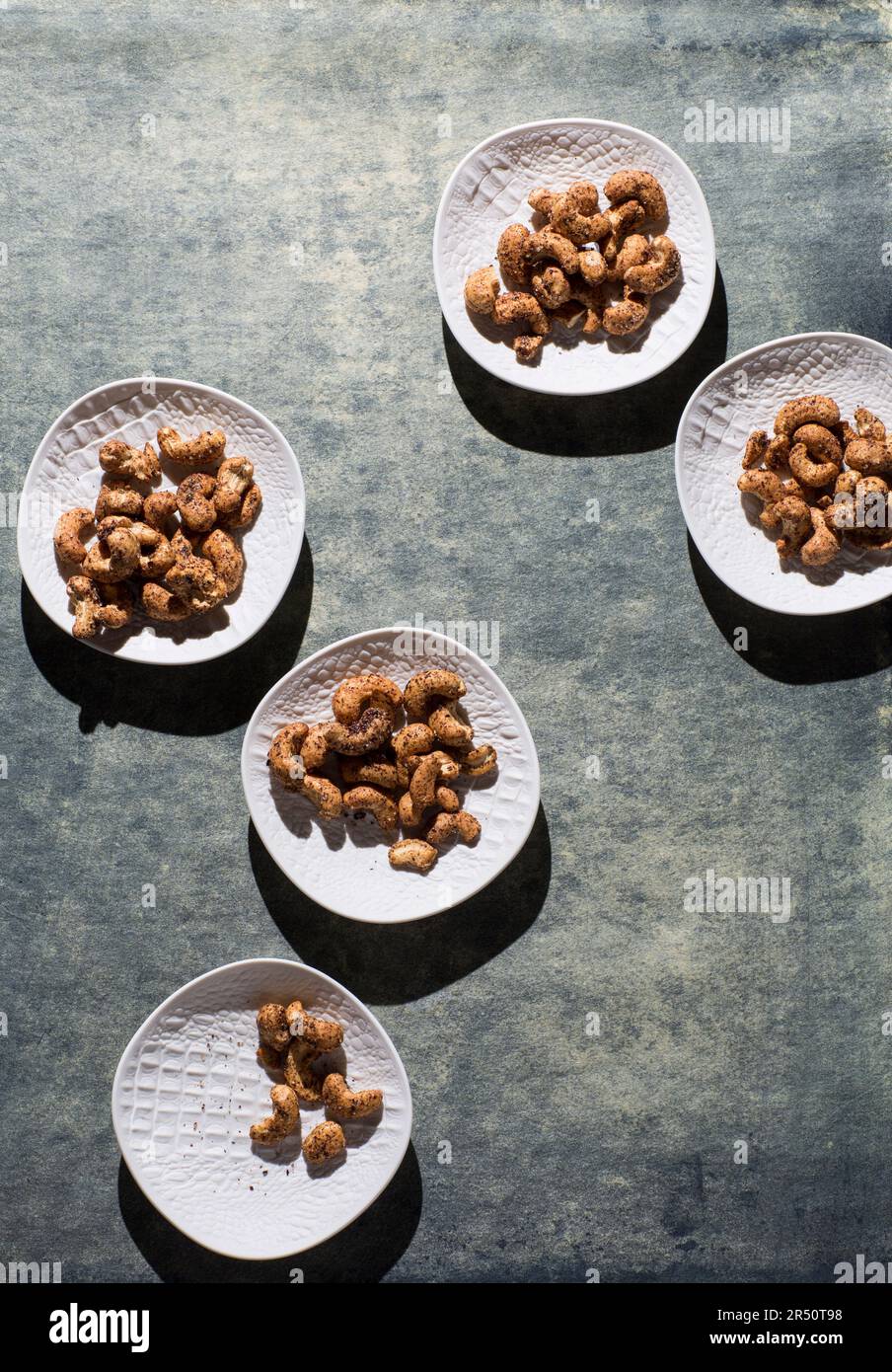 Cashew nuts with hibiscus powder Stock Photo - Alamy