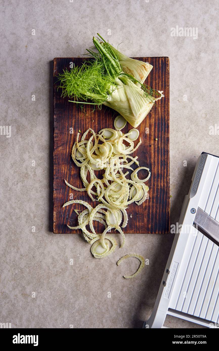 Fresh fennel cut into rings on wooden board Stock Photo - Alamy