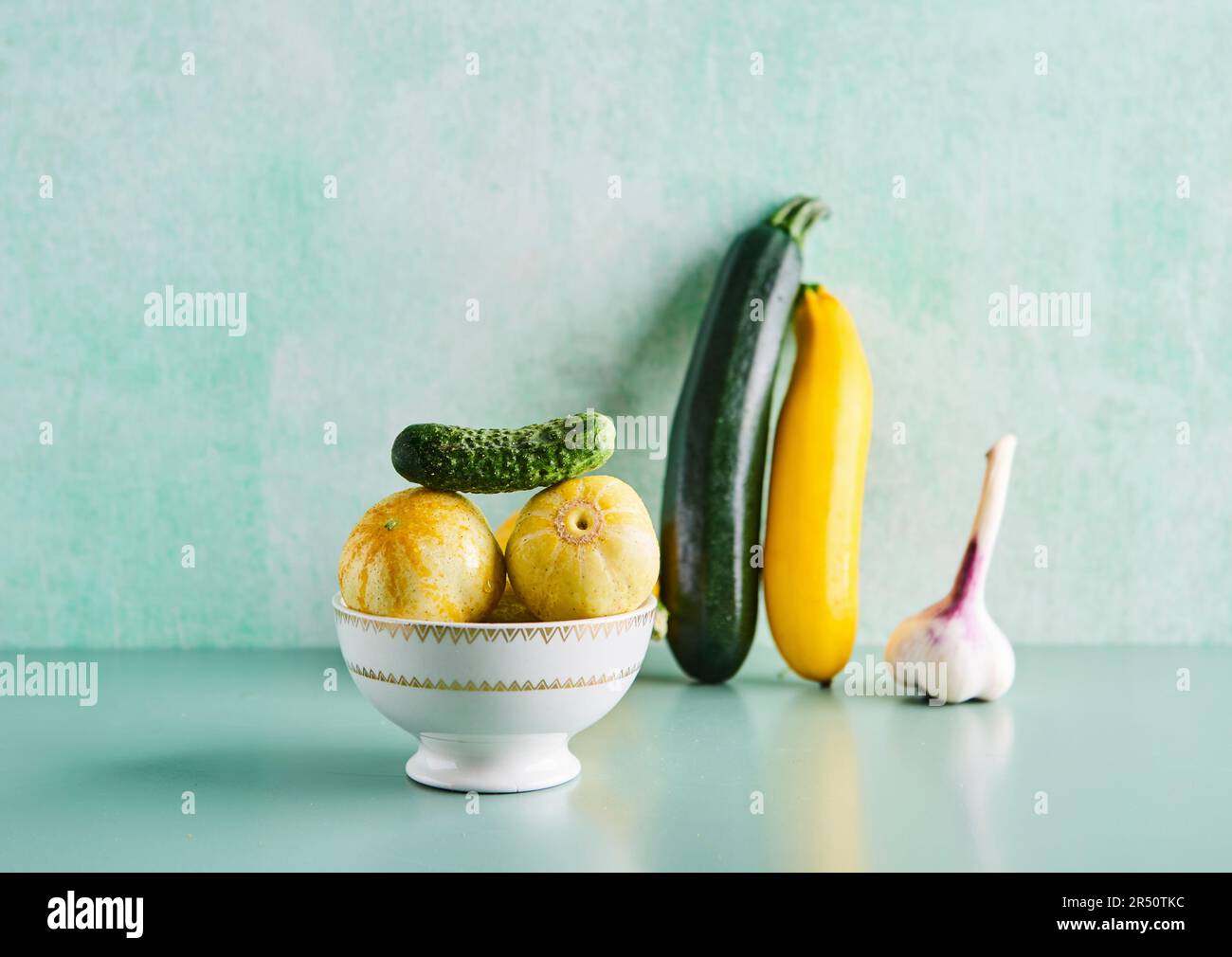 Still life with cucumbers, zucchinis, and fresh garlic Stock Photo - Alamy
