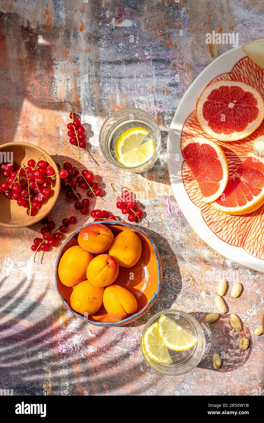 Apricot, red currents, red grapfruit and almond with glasses of ...
