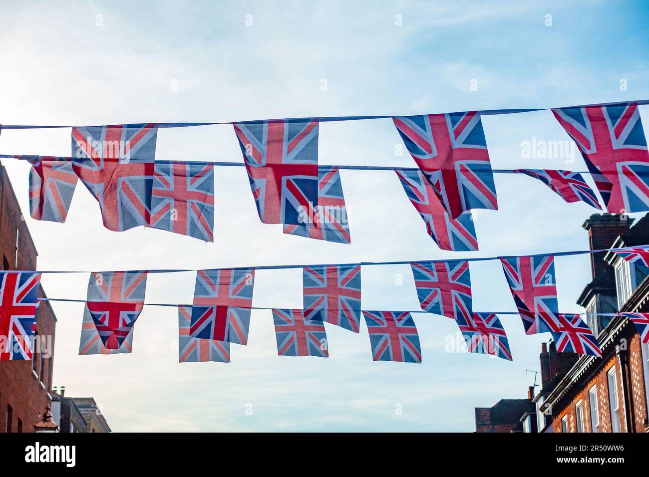 Union Jack bunting strung between buildings, a show of patriotism, in ...