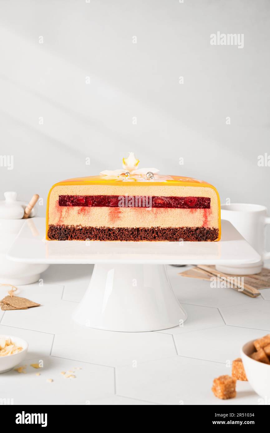 Caramel mousse cake with cherry compote and chocolate sponge cake Stock ...