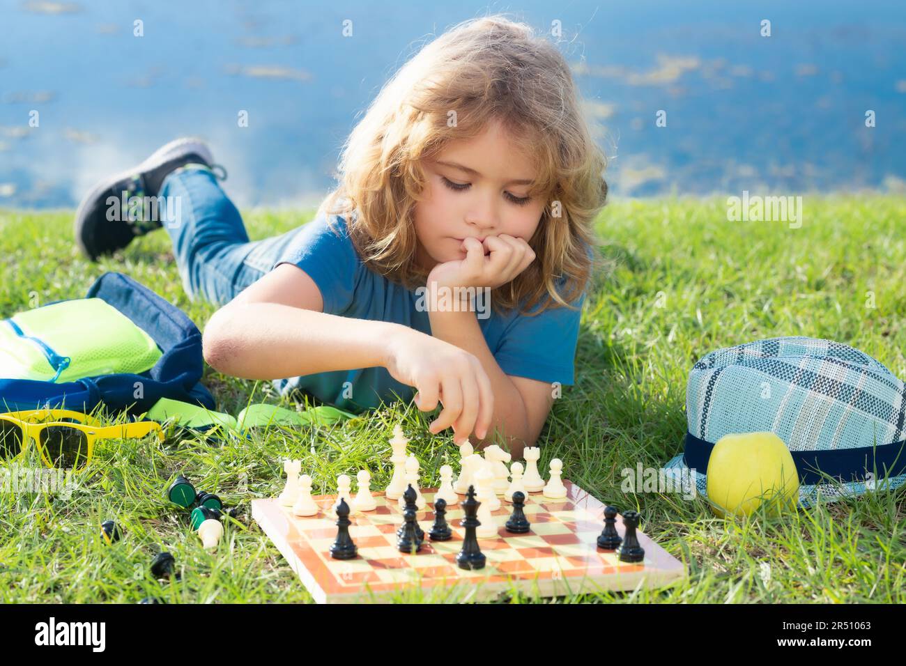 Clever concentrated and thinking kid boy playing chess Stock Photo - Alamy
