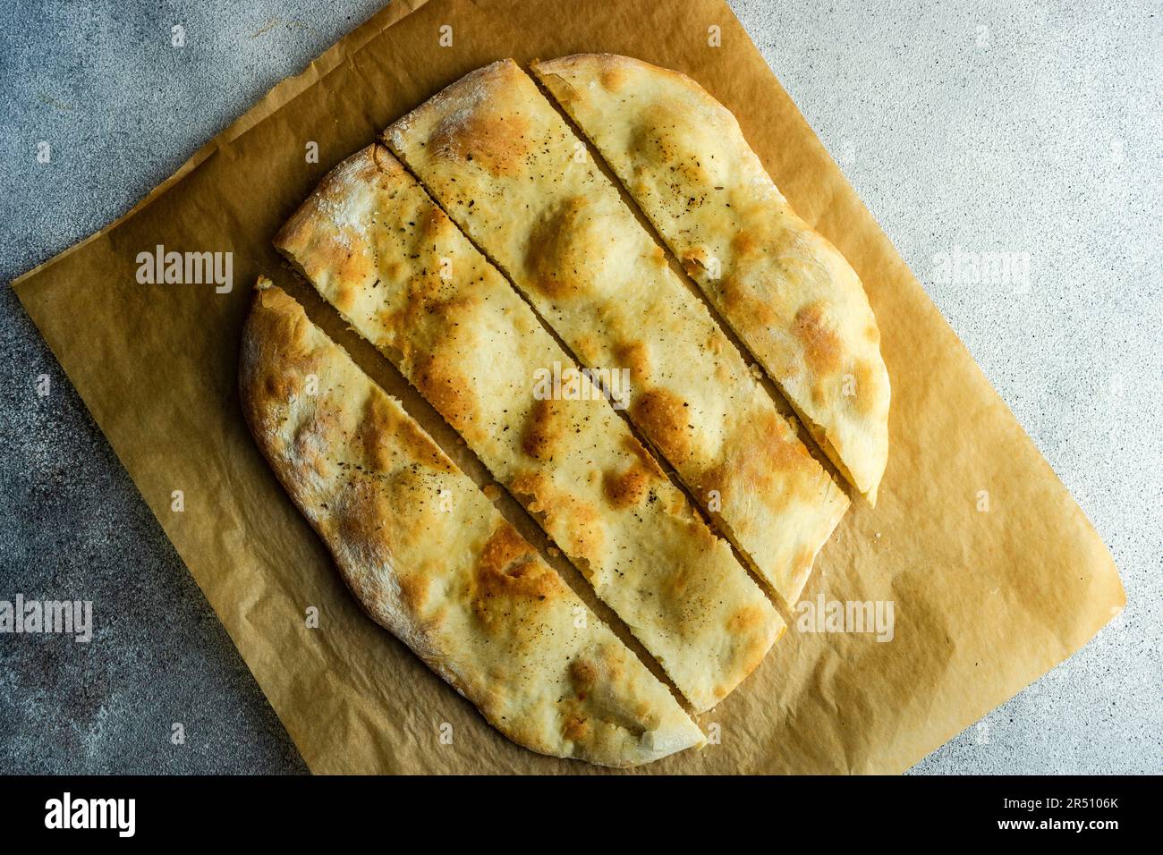 Freshly baked Italian focaccia cut into strips Stock Photo - Alamy
