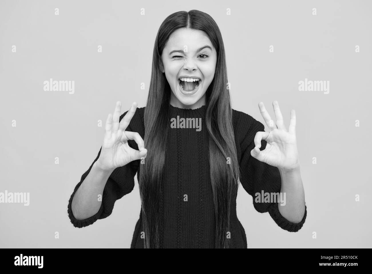 Portrait of a little teenager child girl showing okay gesture and ...