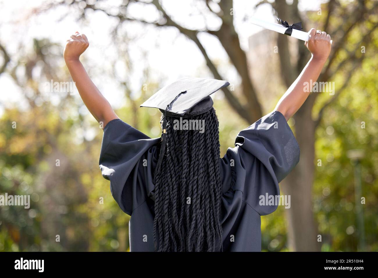 Back, celebration and black woman outdoor, graduation and diploma with ...