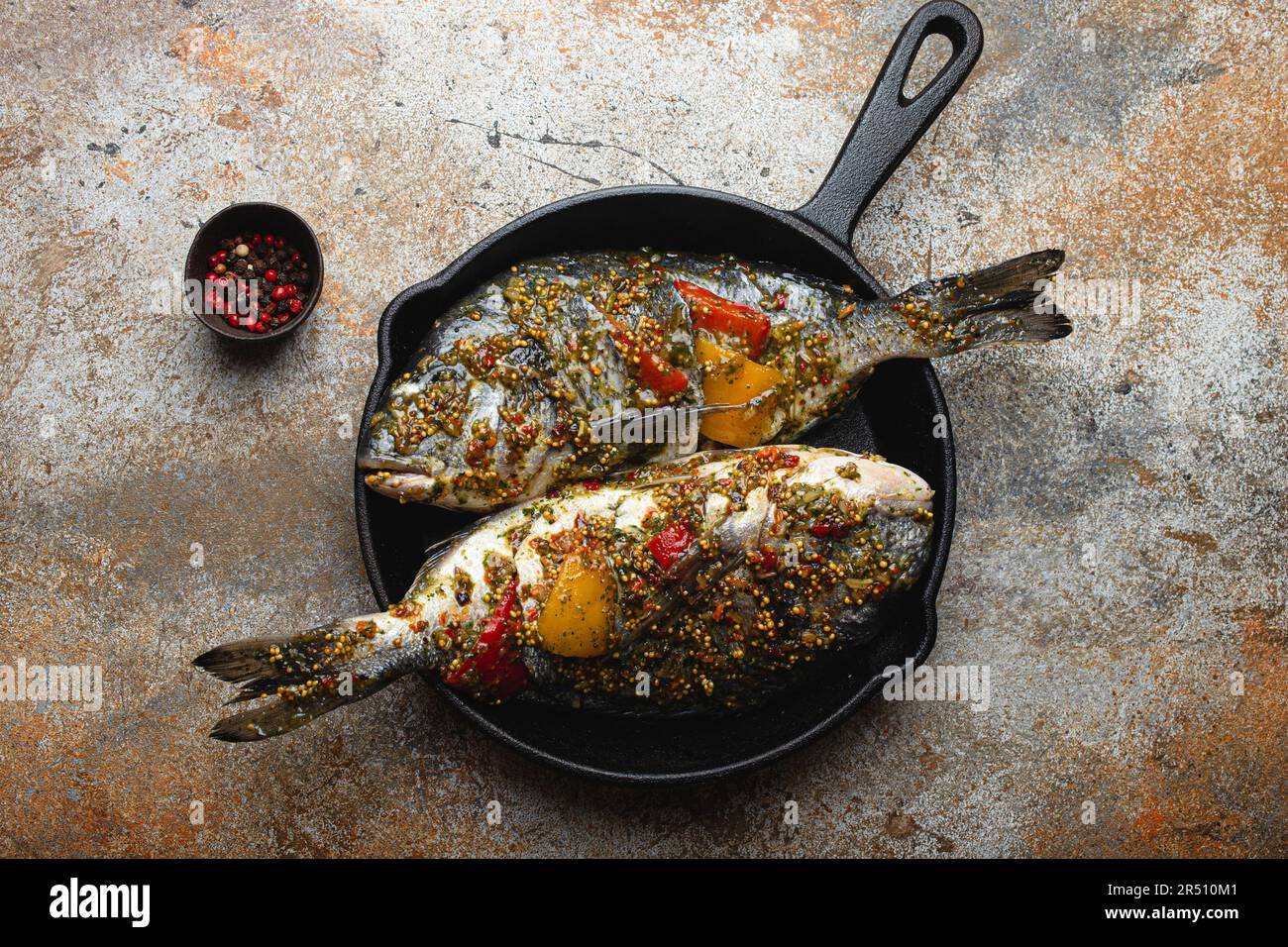 Two raw fishes dorado stuffed with vegetables and seasonings ready to ...