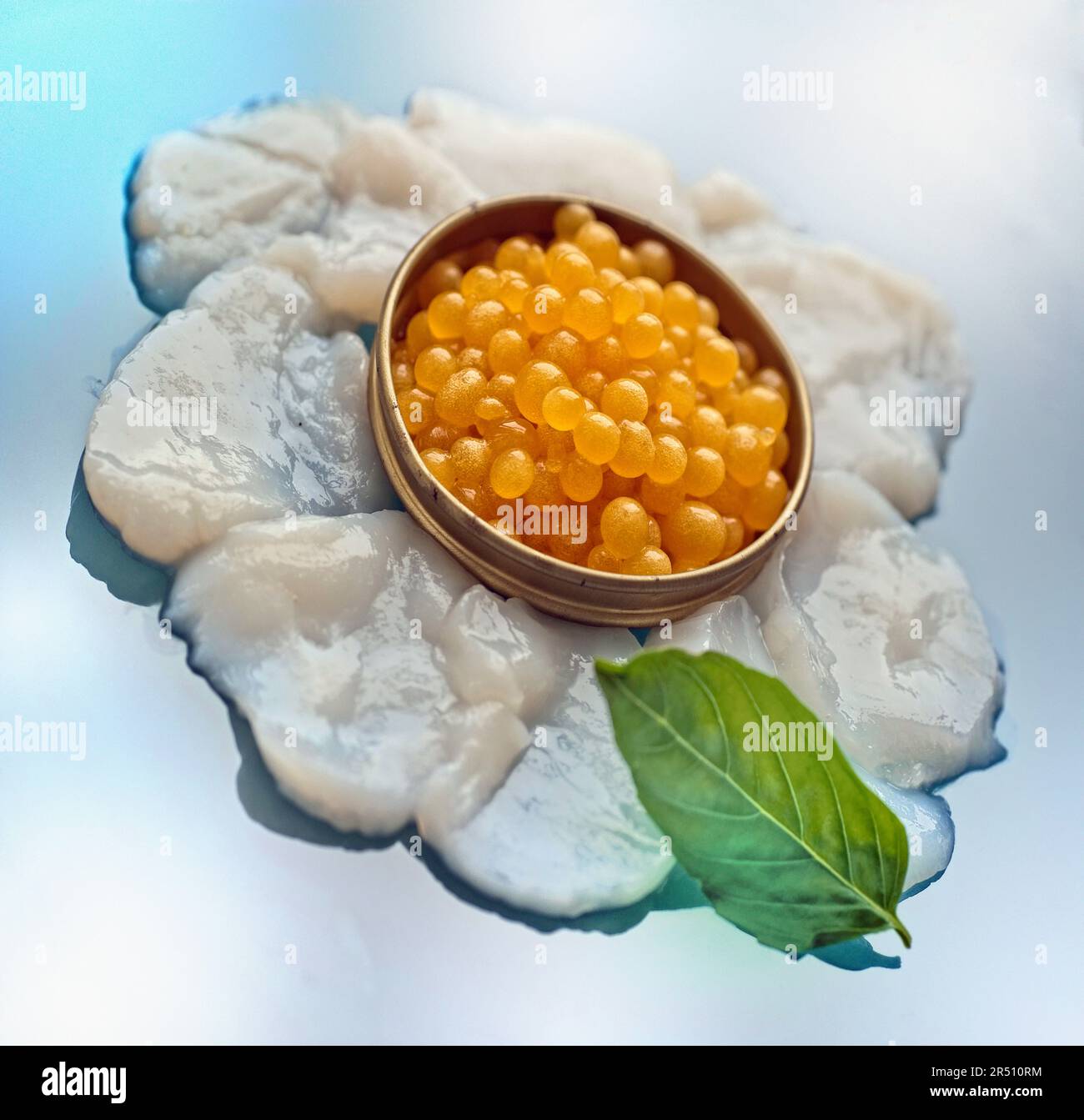 Fish roe in metal bowl on fish carpaccio Stock Photo - Alamy