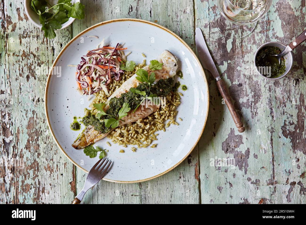 Fish with salsa verde on rice Stock Photo - Alamy