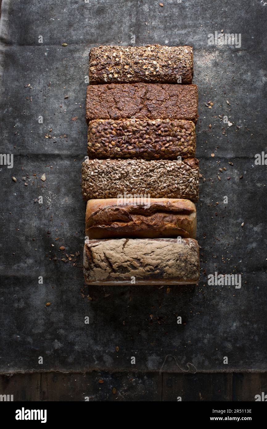 Various loaves in a row Stock Photo - Alamy