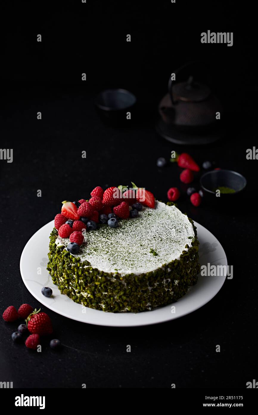 Matcha mille-feuille cake with pistachios and summer berries Stock ...