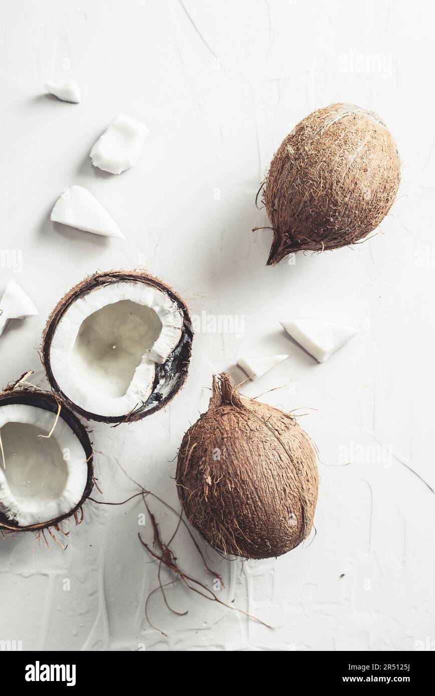 Coconuts, whole and broken open Stock Photo - Alamy
