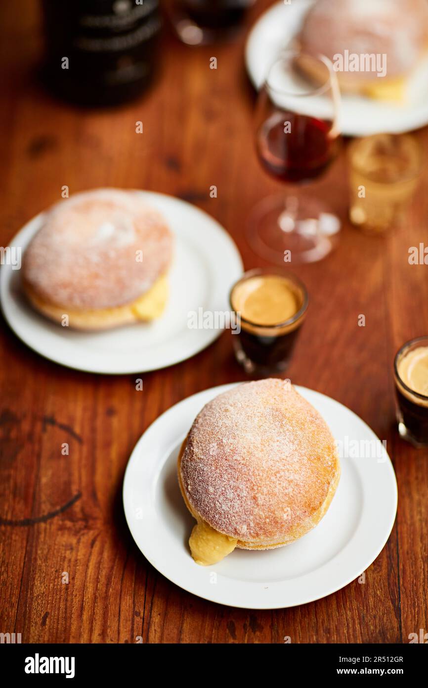 Pudding-filled doughnuts with espresso and wine Stock Photo - Alamy