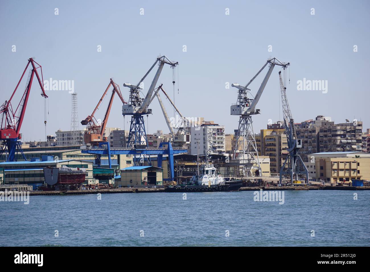 Ships and cranes of the Suez canal in the city of Portsaid Stock Photo ...