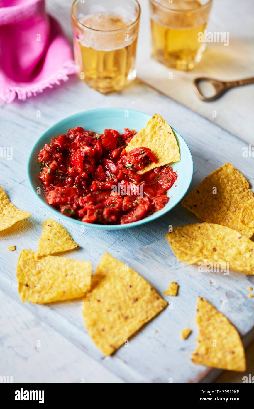 Tortilla chips with tomato salsa Stock Photo - Alamy