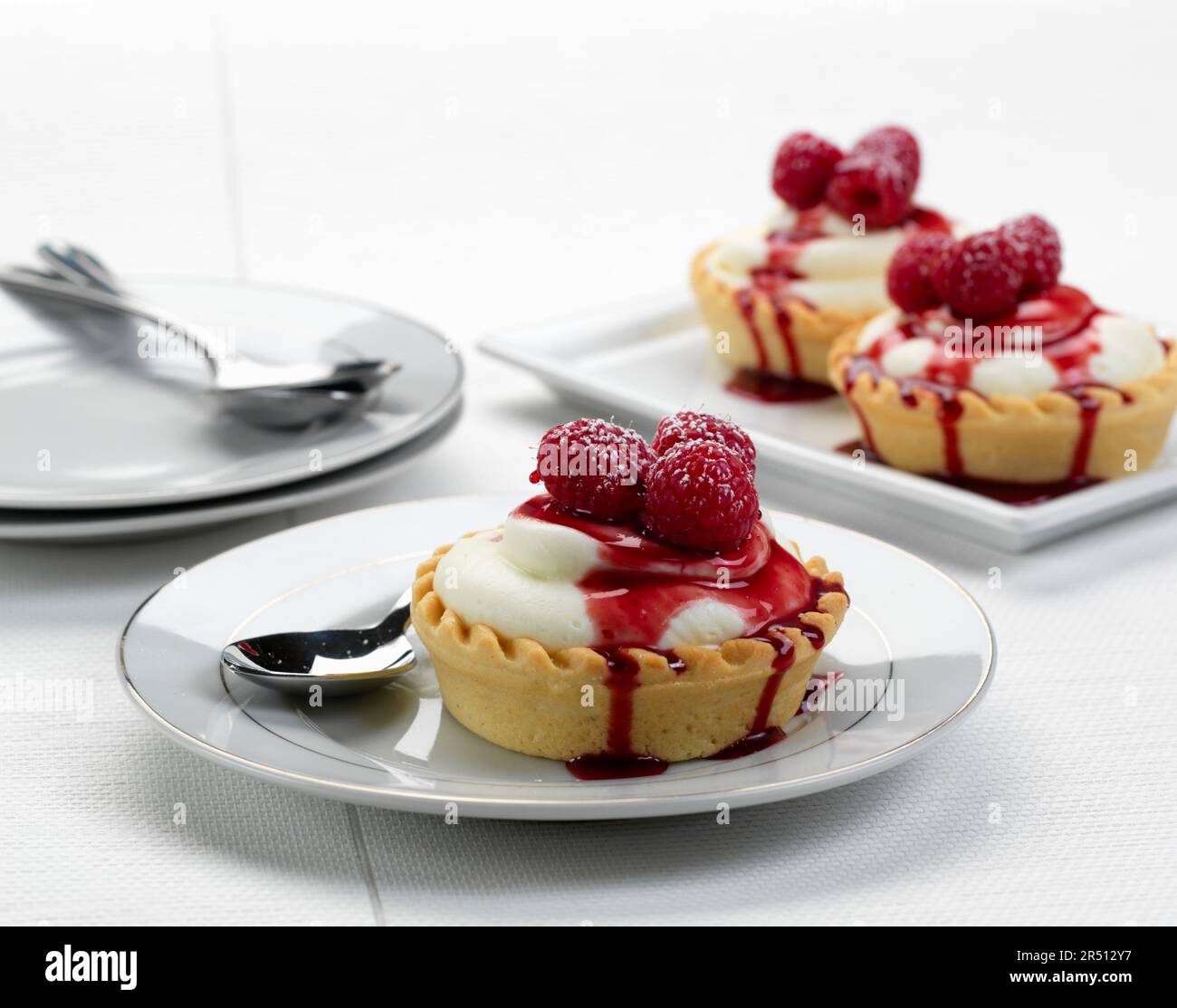 White chocolate mousse tartlets with raspberries Stock Photo - Alamy