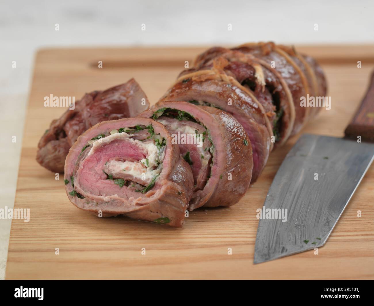 Rolled flank steaks with stuffing Stock Photo - Alamy