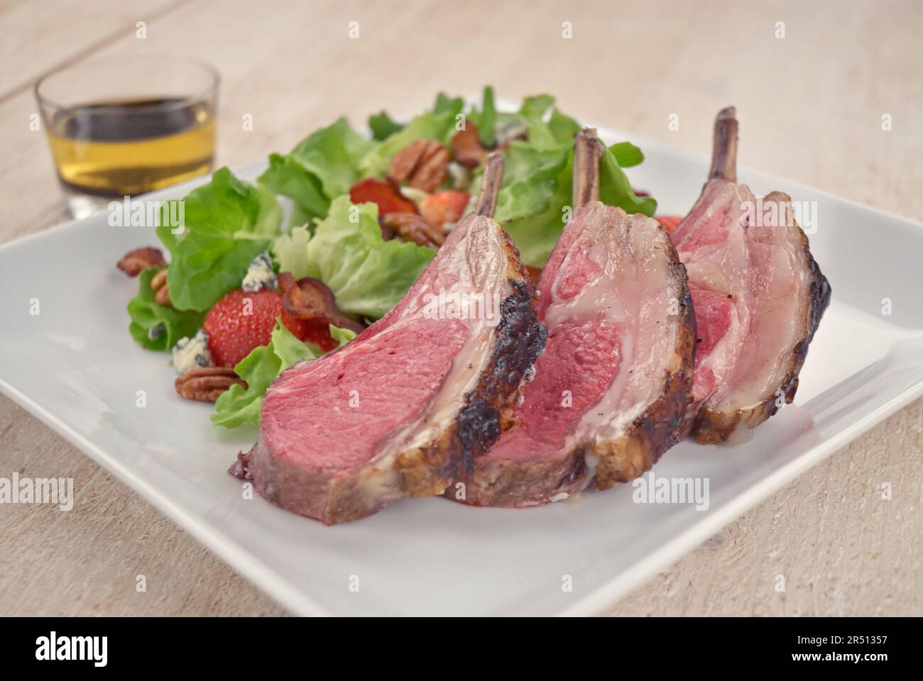 Rack of lamb served with salad with blue cheese, strawberries and bacon ...