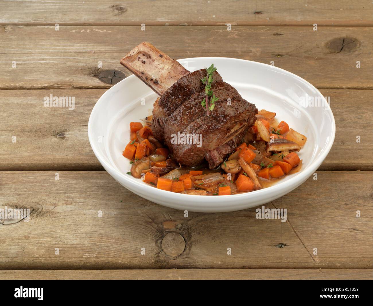 Grilled short ribs on a bed of vegetables Stock Photo - Alamy