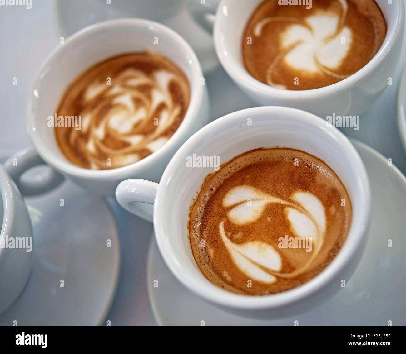 Three cappuccinos with different milk foam patterns Stock Photo - Alamy