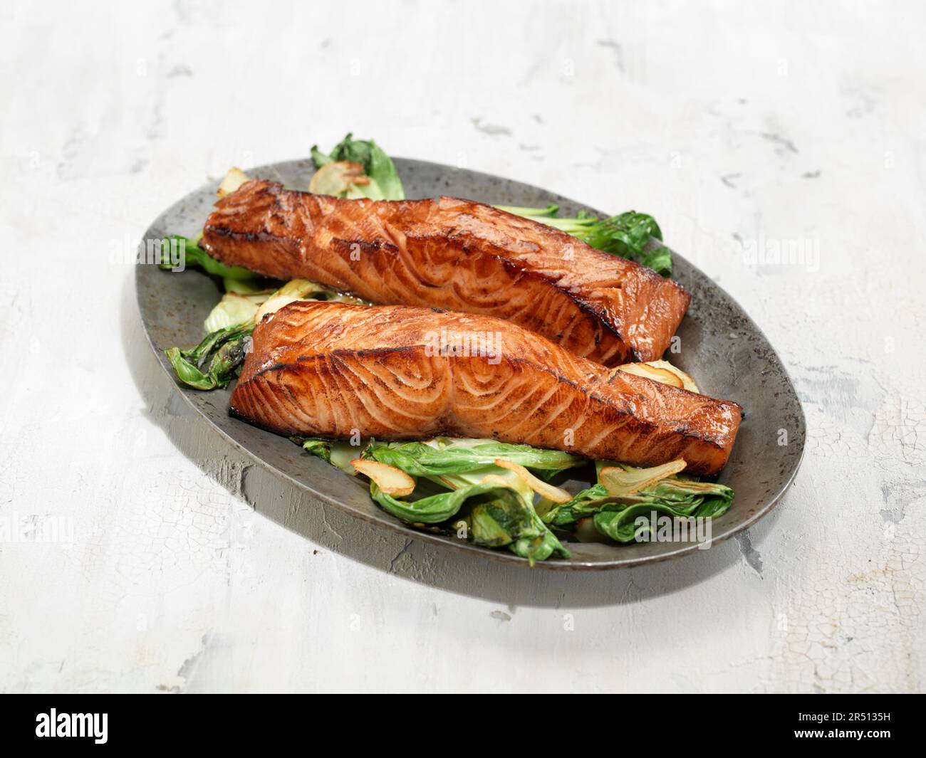 Grilled salmon on a bed of vegetables Stock Photo - Alamy