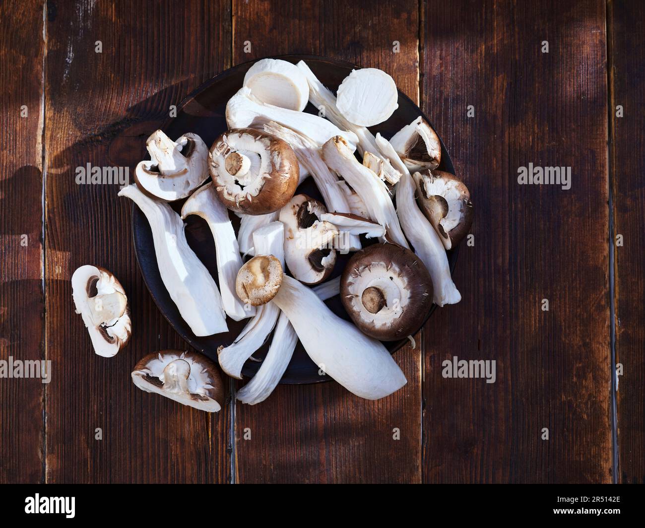 Top view various mushrooms cut on a plate Stock Photo - Alamy