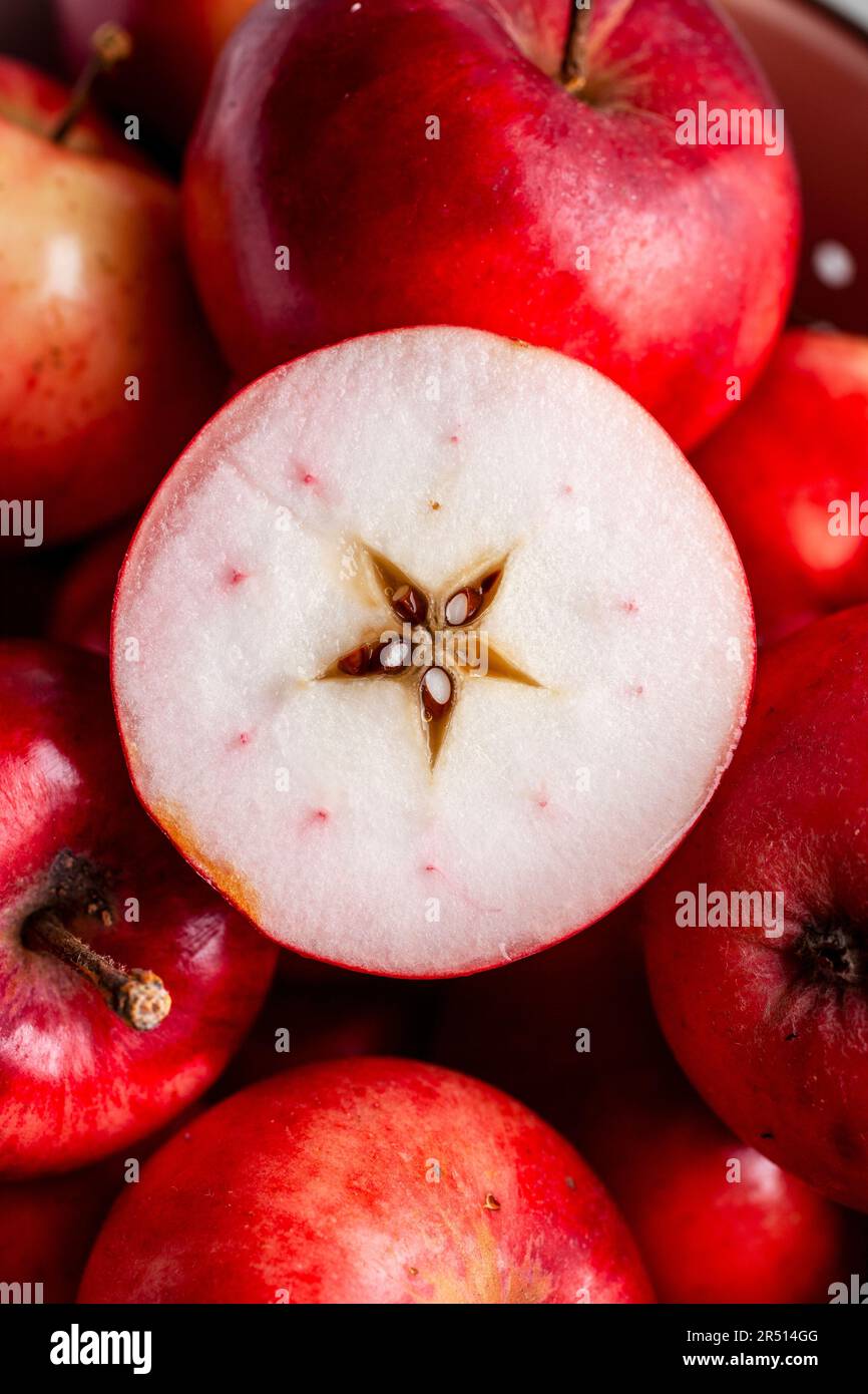 Fresh red apples, one cut in half (Close Up Stock Photo - Alamy