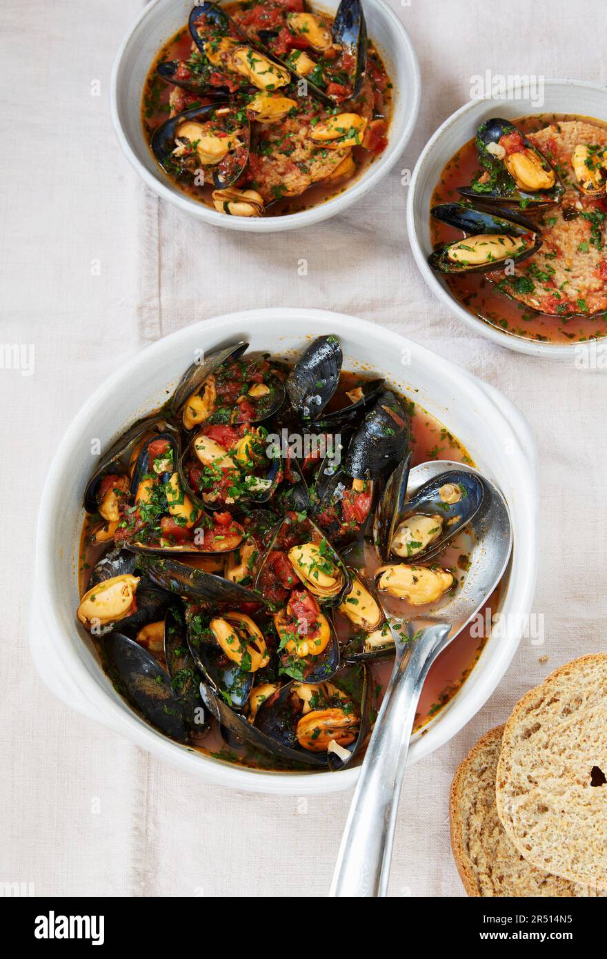Italian mussel soup served with friselle Stock Photo - Alamy
