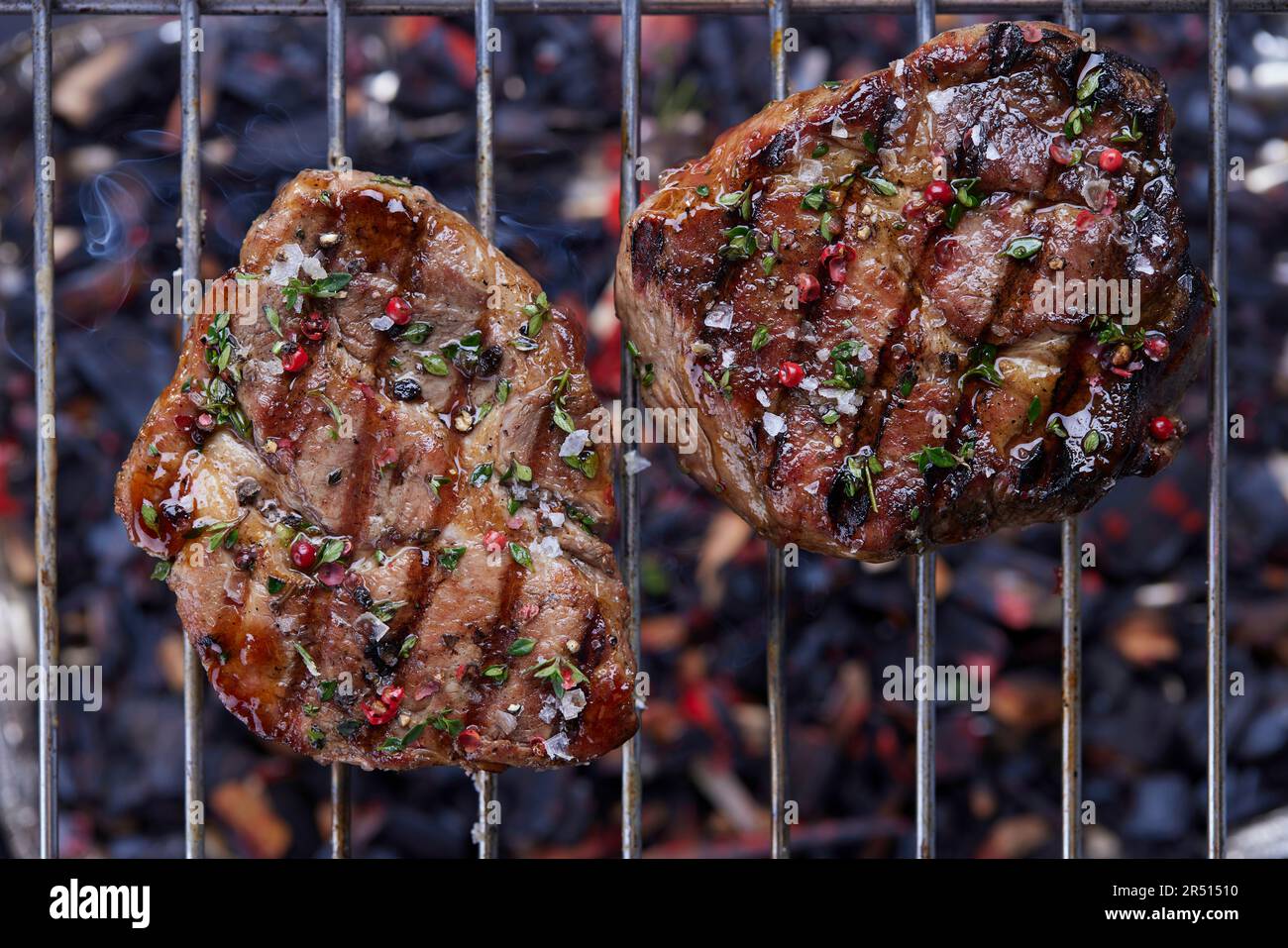Grilled pork neck steaks on grill rack Stock Photo - Alamy