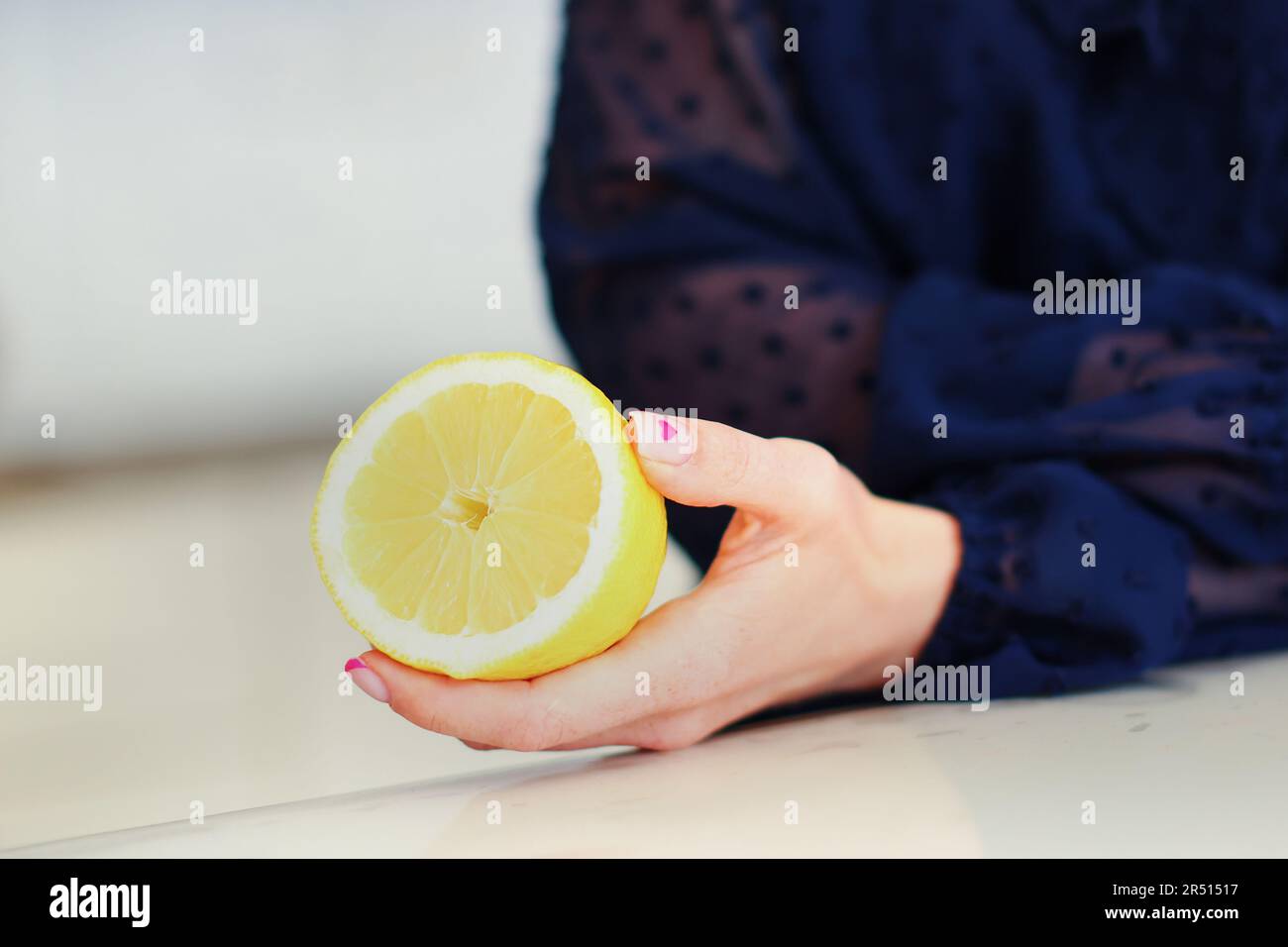 hand holding lemon on white background Stock Photo - Alamy