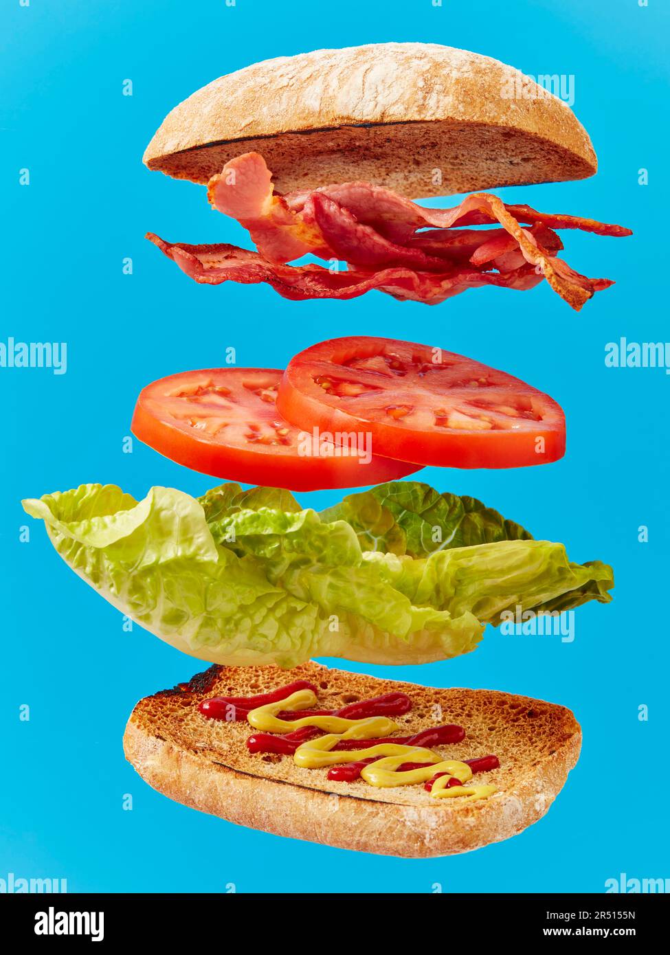 Floating sandwich against a blue background Stock Photo - Alamy