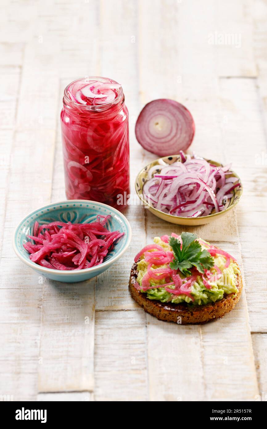 Bread topped with avocado cream and pickled red onions Stock Photo - Alamy