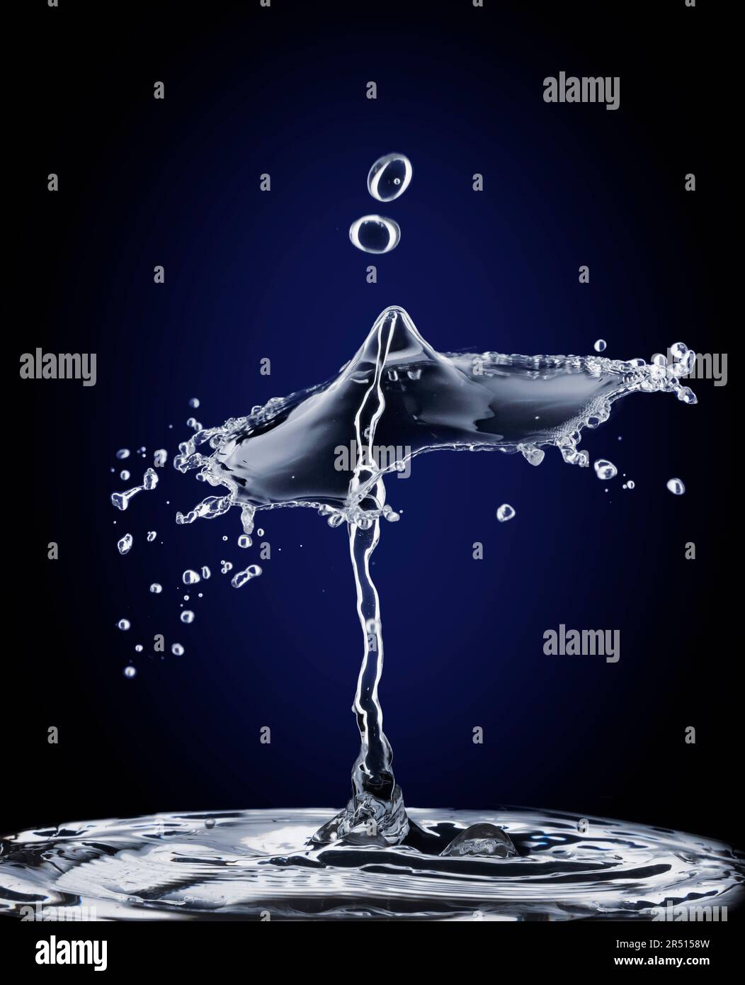 Water splash against a dark background Stock Photo - Alamy