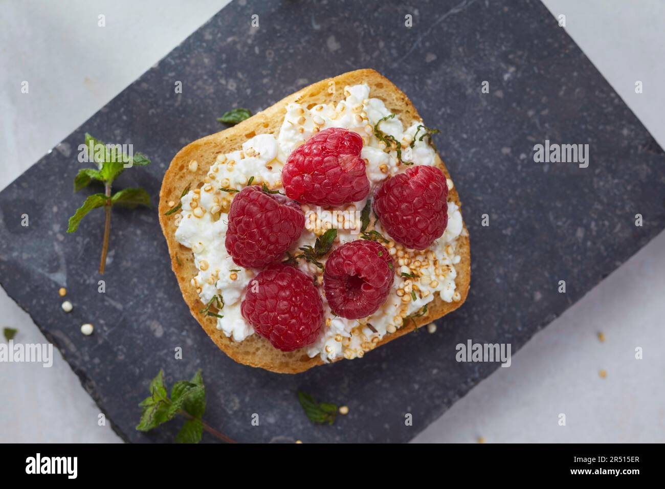 Light organic bread with cottage cheese, quinoa and raspberries Stock ...