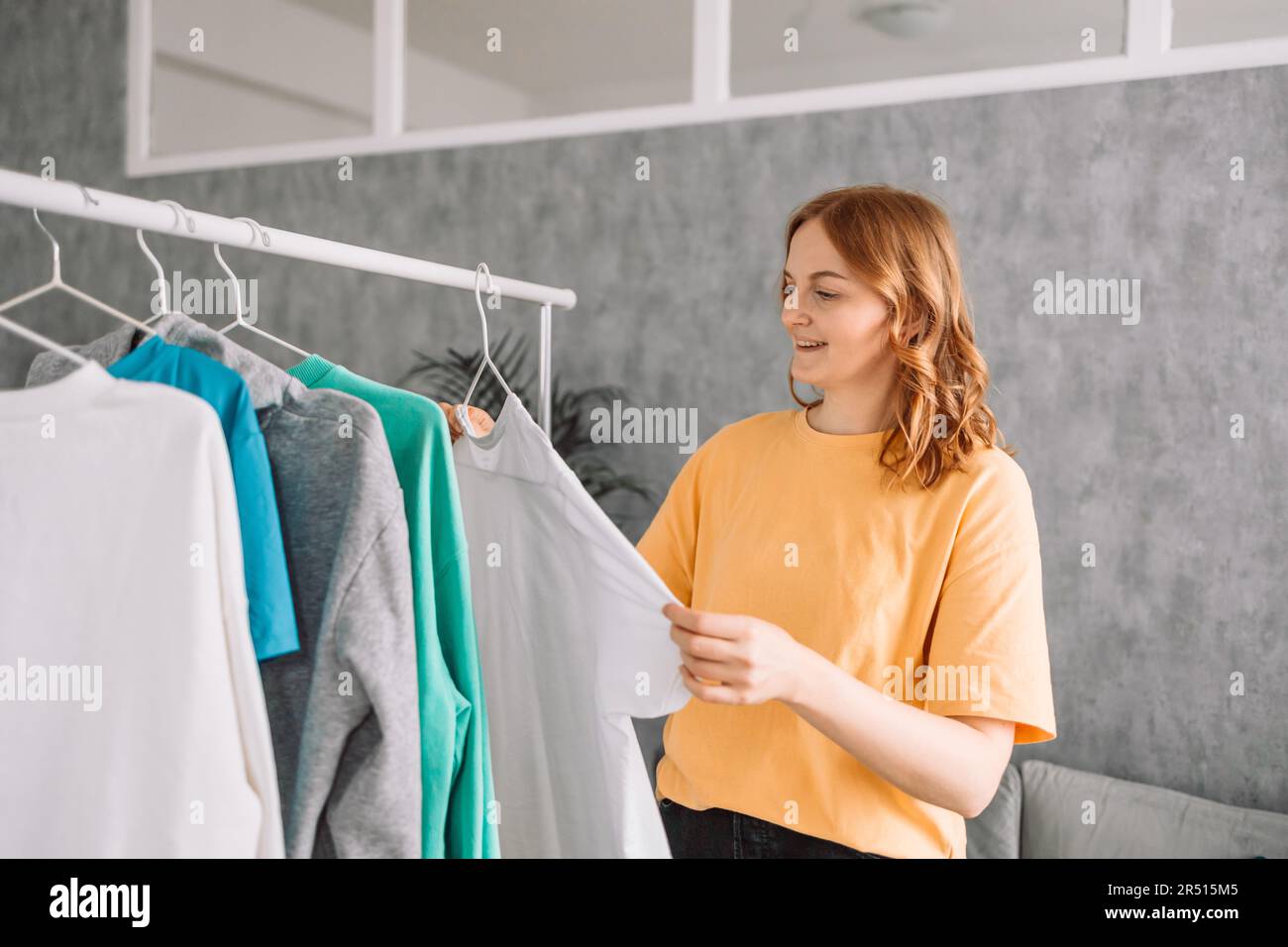 Image of pleased Caucasian young adult woman using cell phone, reading ...