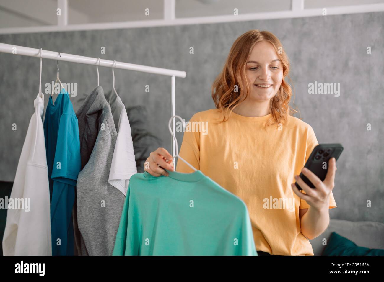 Image of pleased Caucasian young adult woman using cell phone, reading ...