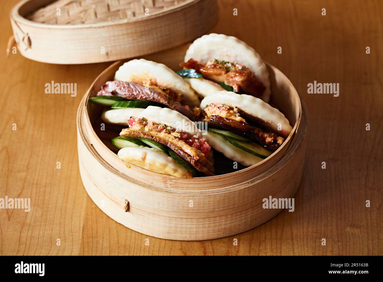 Bao bun in a steamer basket Stock Photo - Alamy