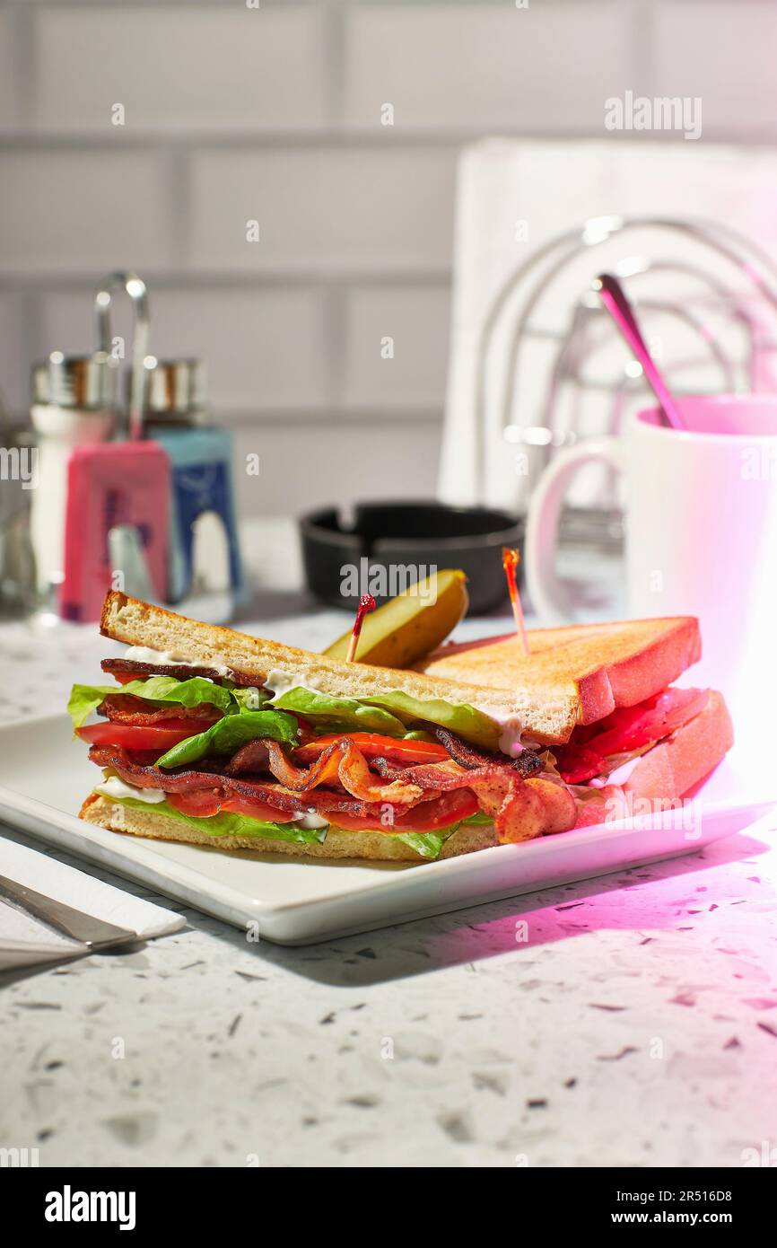 BLT sandwich with cucumber on bistro table Stock Photo - Alamy
