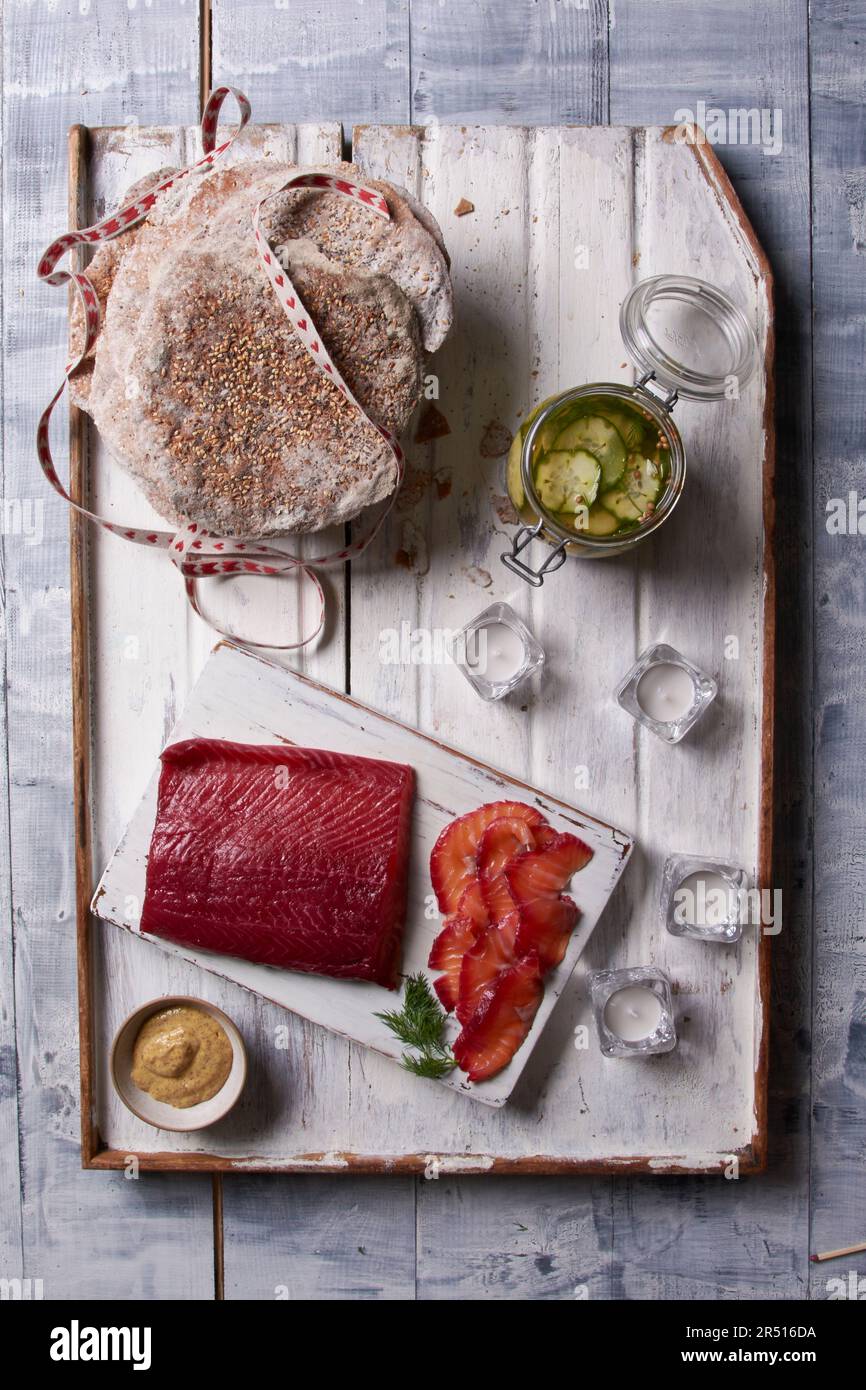 Pickled salmon, rustic bread and pickled cucumber Stock Photo - Alamy